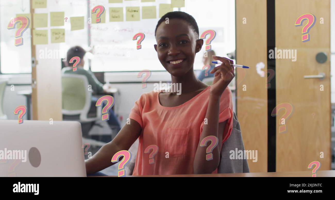Image of question marks over african american businesswoman working at ...