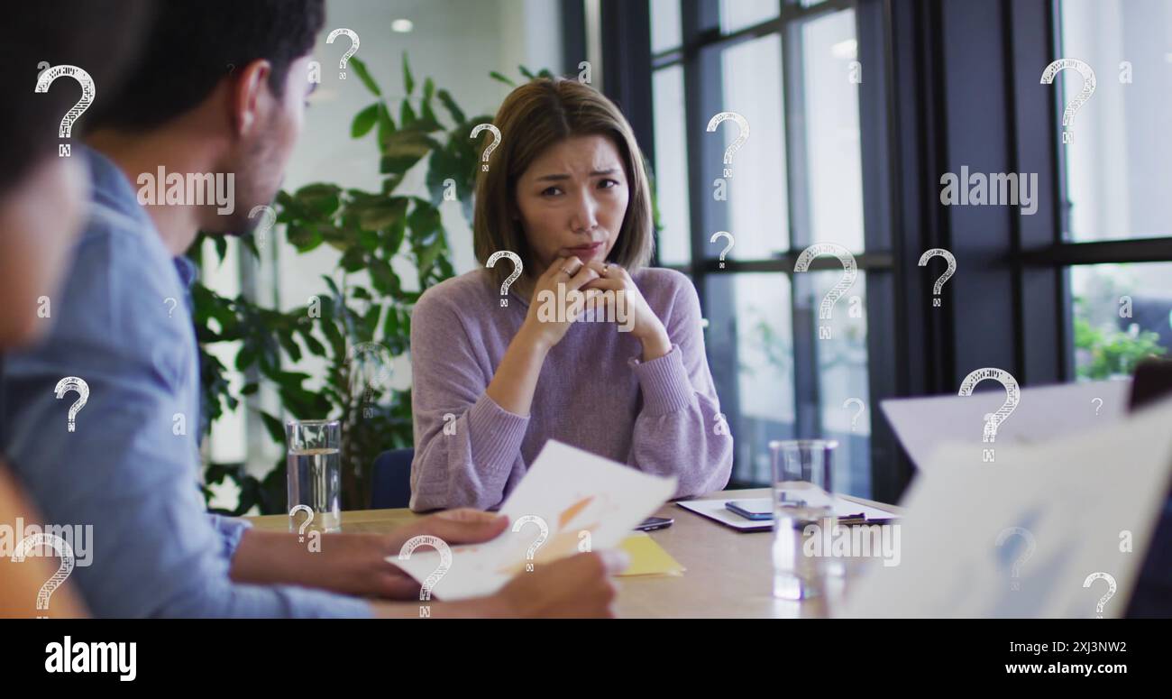 Image of question marks over diverse business people having meeting at ...