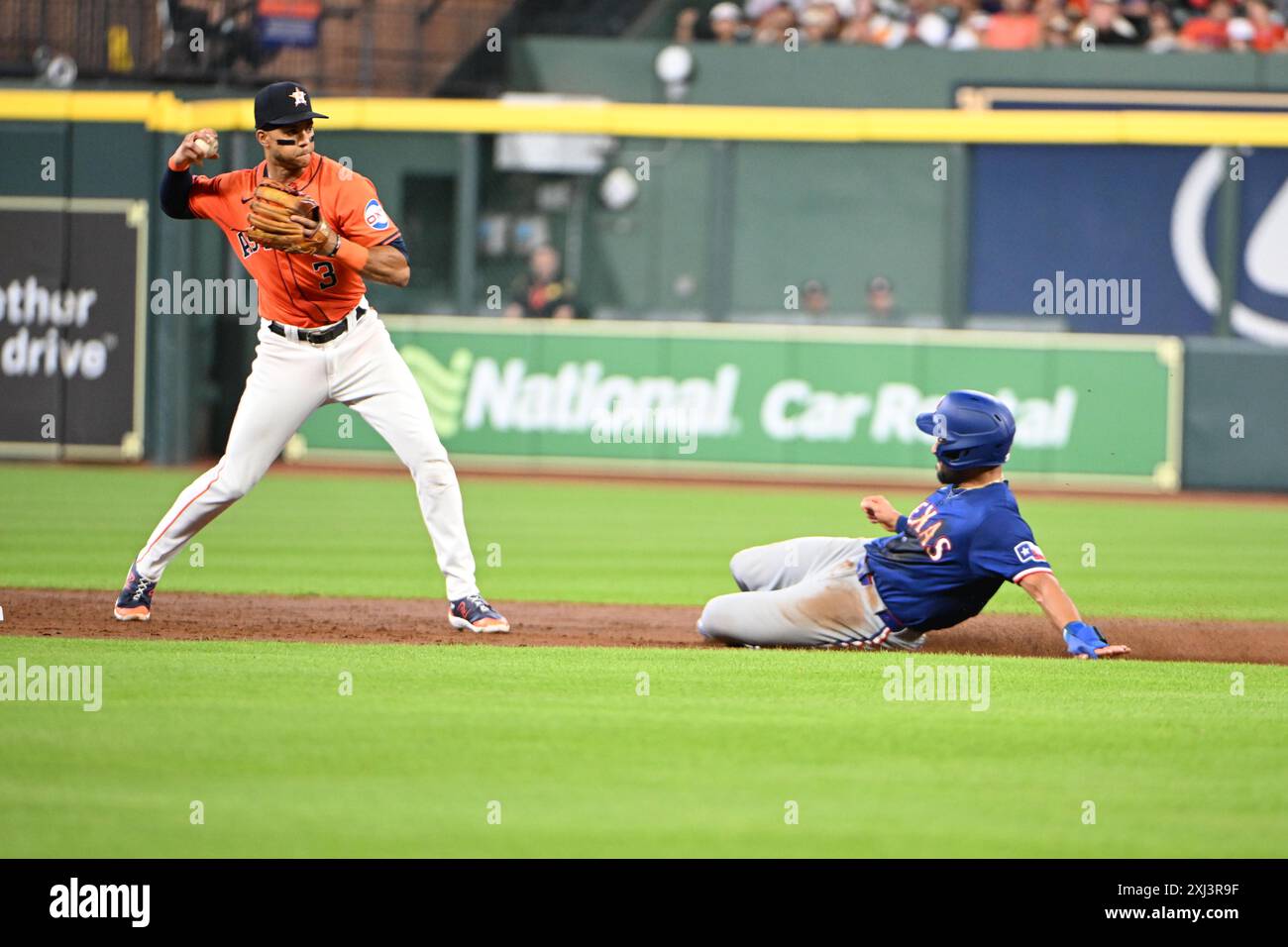 Houston Astros shortstop Jeremy Peña (3) turns a double play as Texas ...