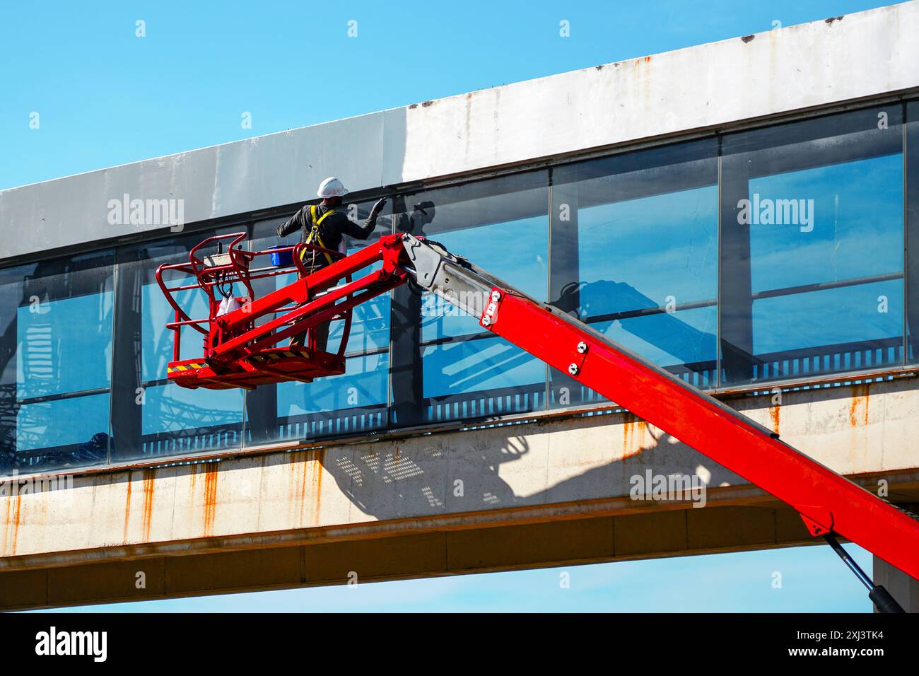 Elevated pedestrian overground tunnel facade painting using a ...