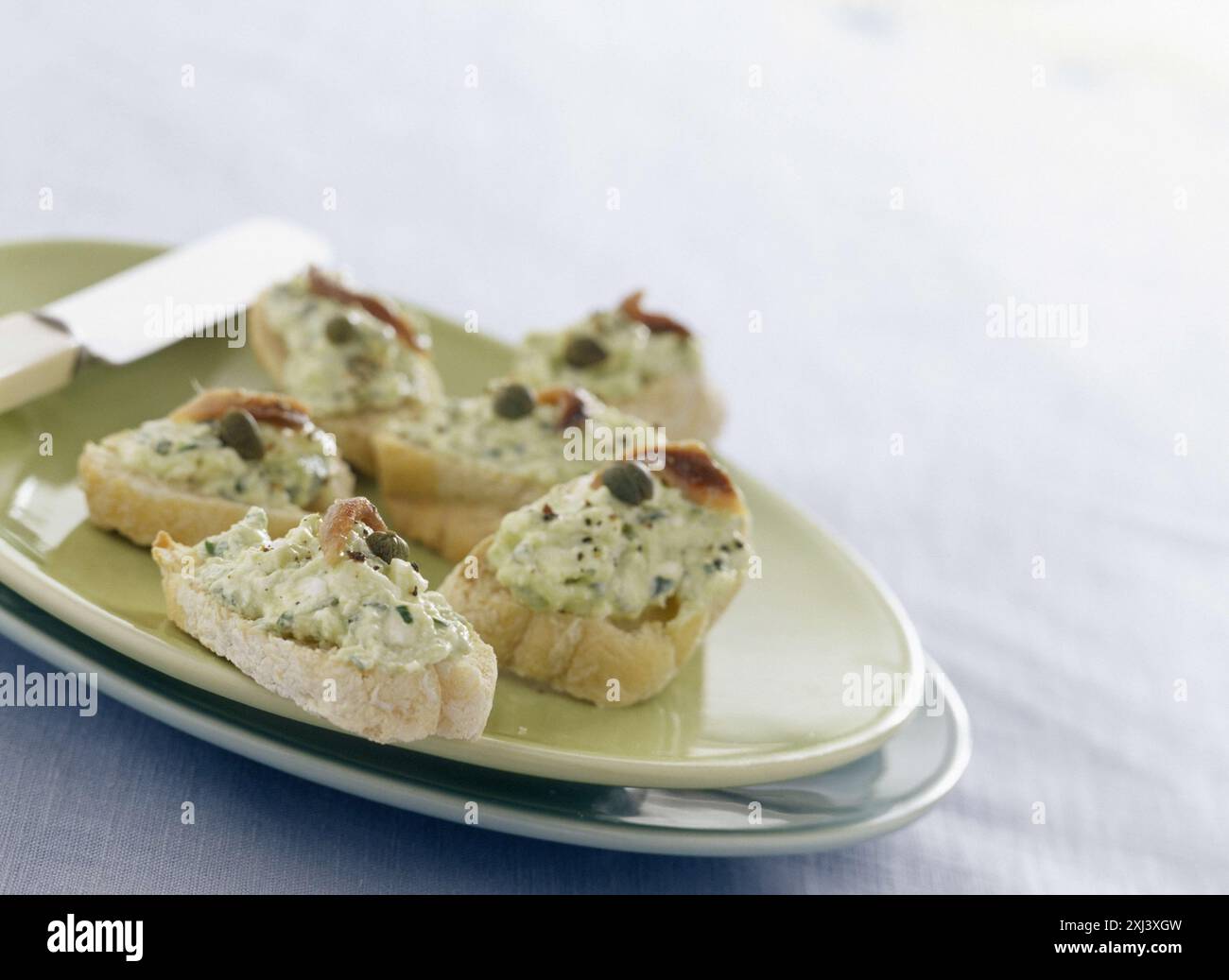 Feta mousse with anchvies and capers on toasts Stock Photo - Alamy