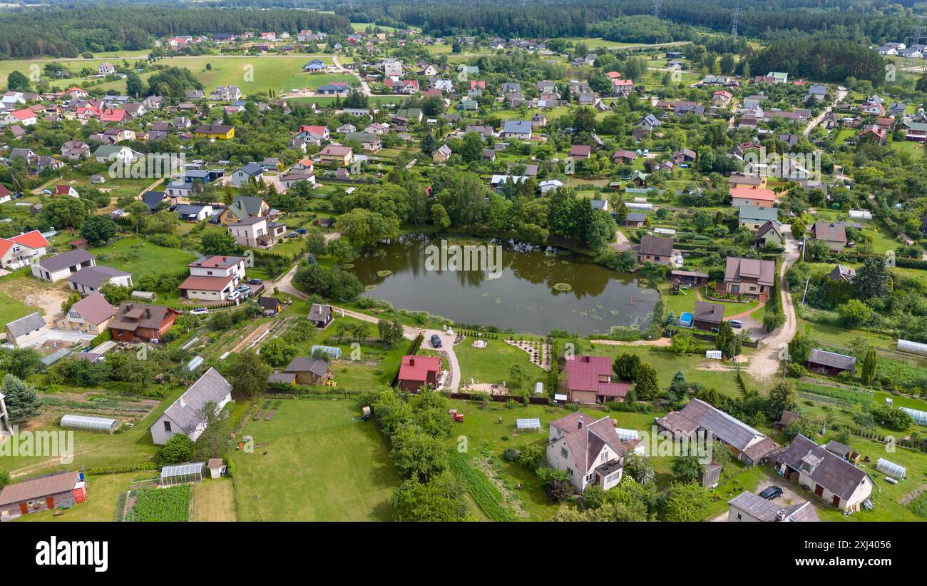 Drone photography of small town surrounded by forest during summer ...