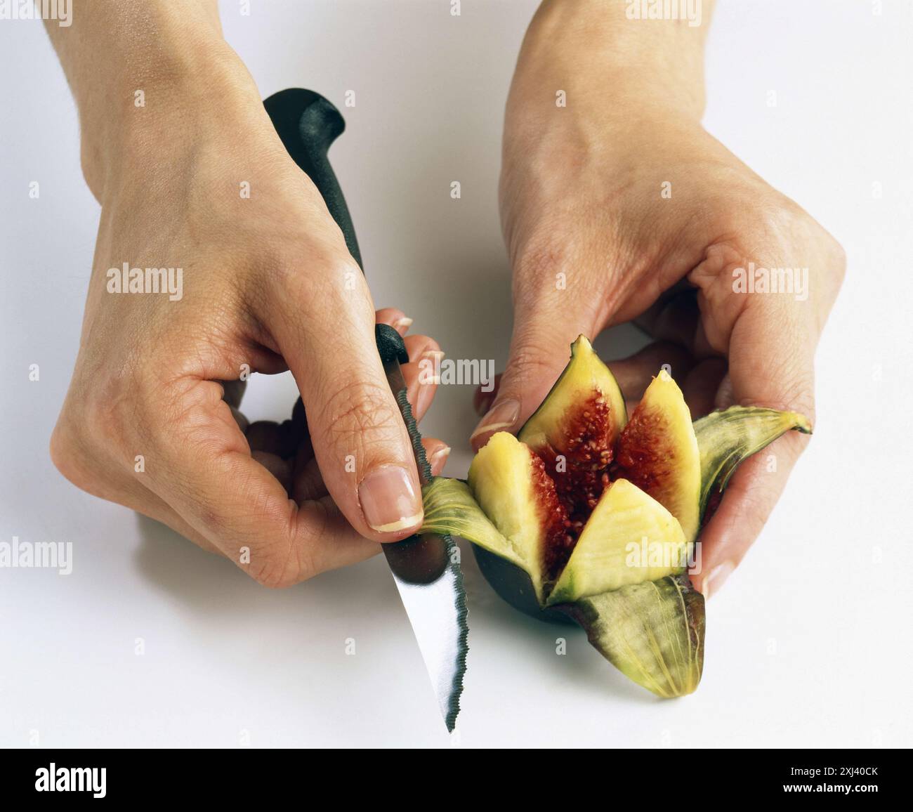 cutting the fig in the shape of a flower Stock Photo - Alamy