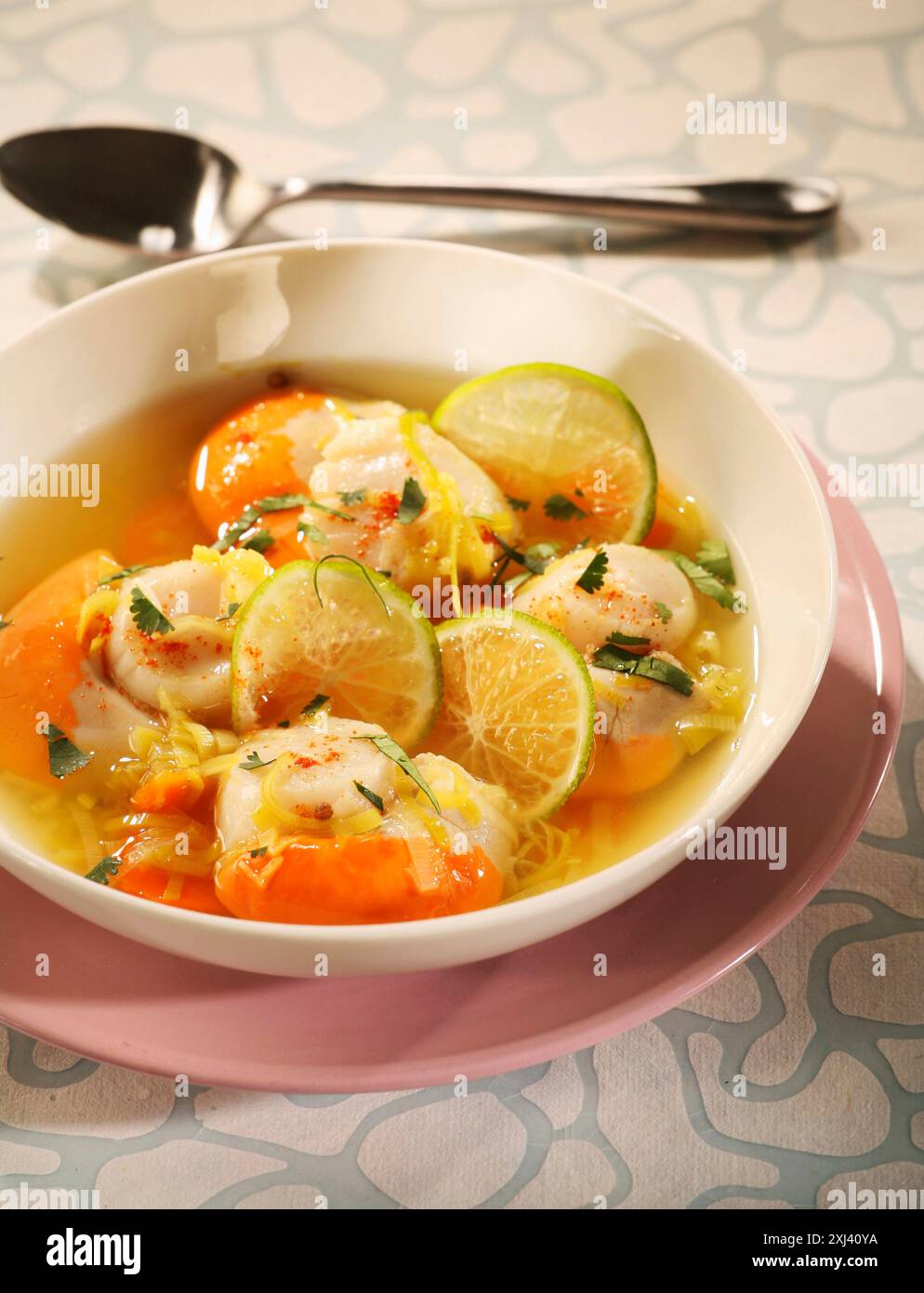 Scallop soup with citrus fruit and coriander Stock Photo - Alamy