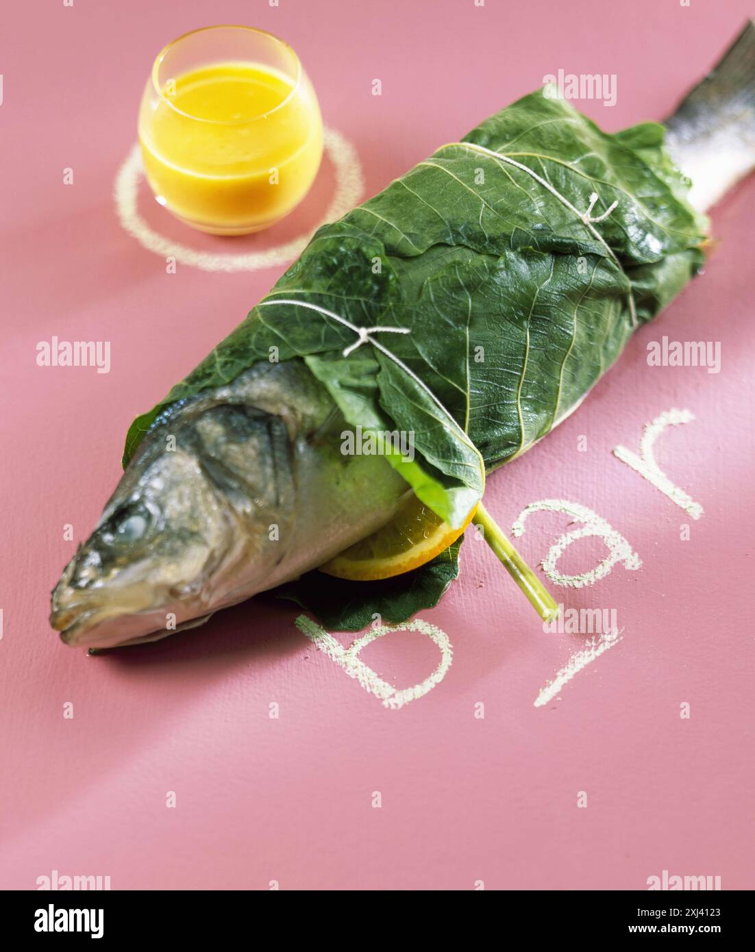 Bass wrapped in fig leaf Stock Photo - Alamy