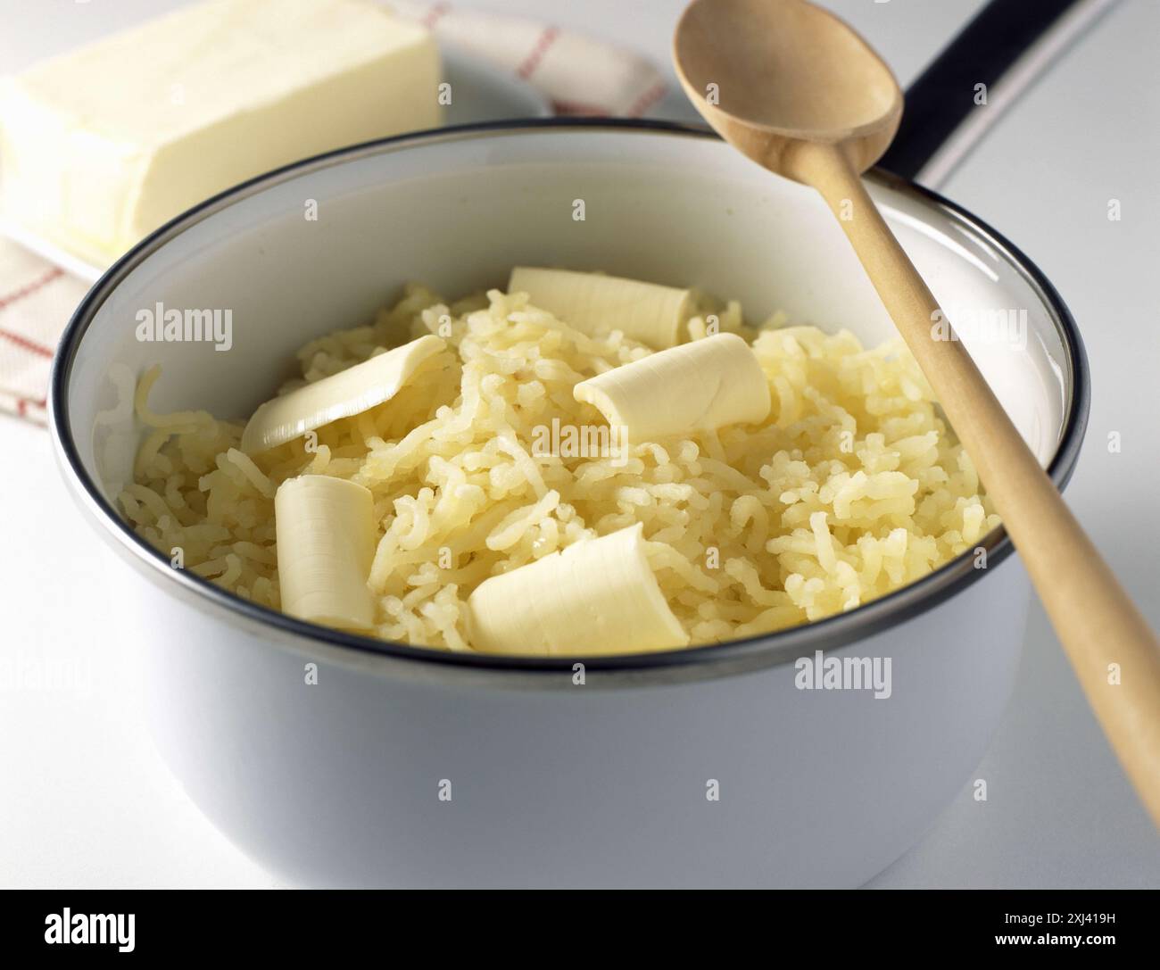 Adding the butter Stock Photo - Alamy
