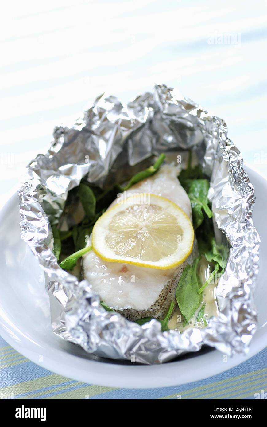 Pollock and lemon cooked in aluminium foil Stock Photo - Alamy