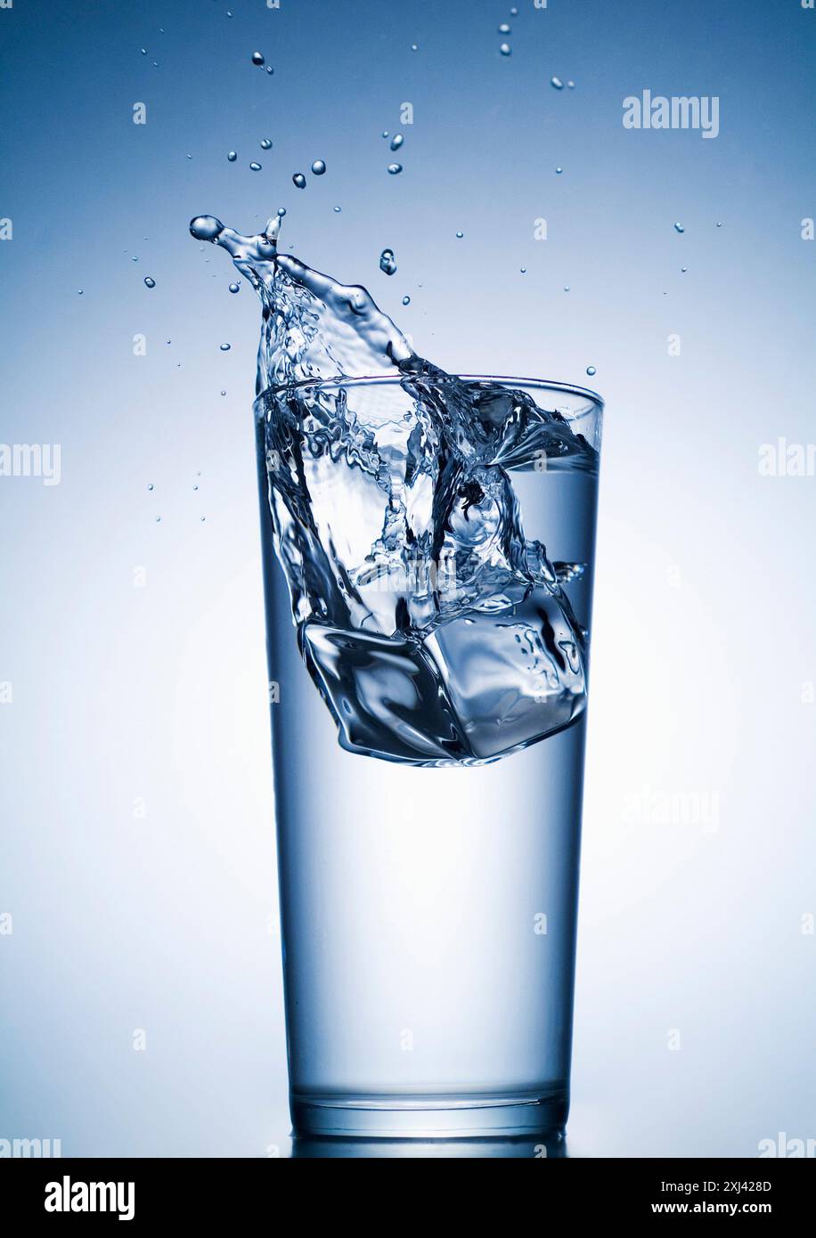 ice cube falling into glass of water Stock Photo - Alamy