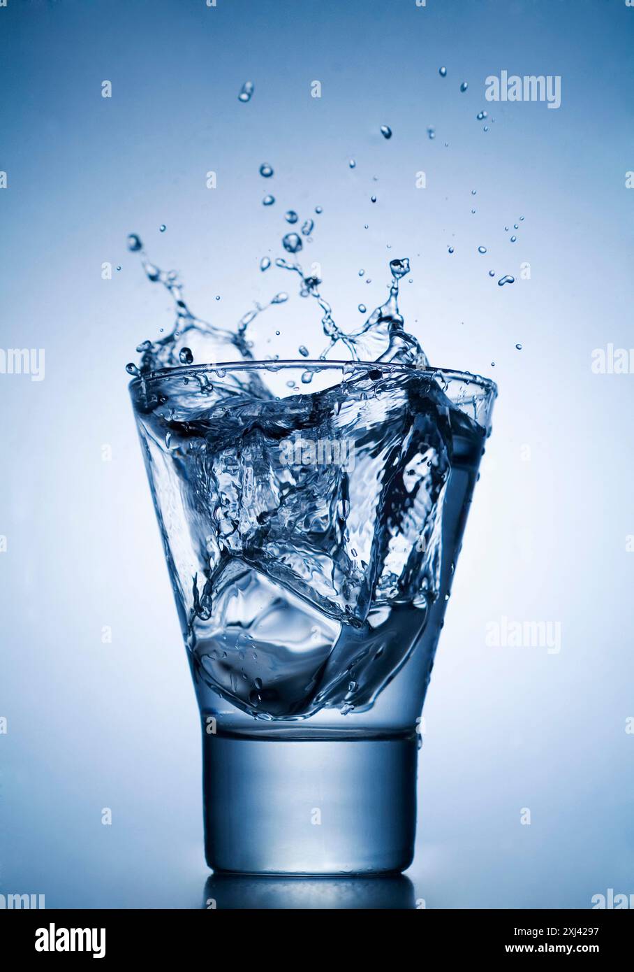 ice cube falling into glass of water Stock Photo - Alamy