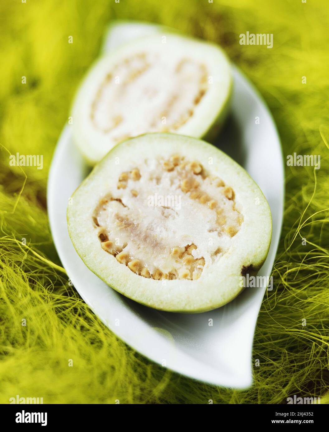 Guava cut in two Stock Photo - Alamy