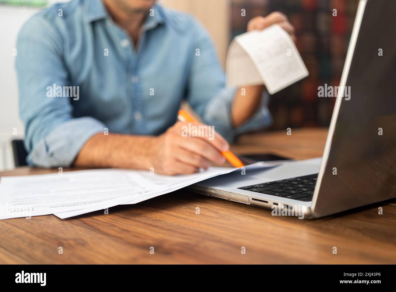 Businessman holds transaction check filling tax forms indicating ...