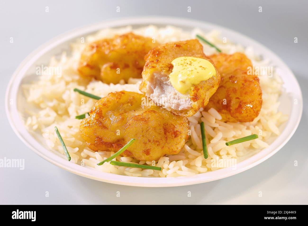 Chicken nuggets wth rice Stock Photo - Alamy