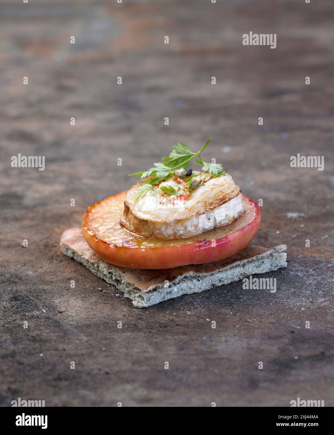 Toasted slice of apple with goat's cheese Stock Photo - Alamy