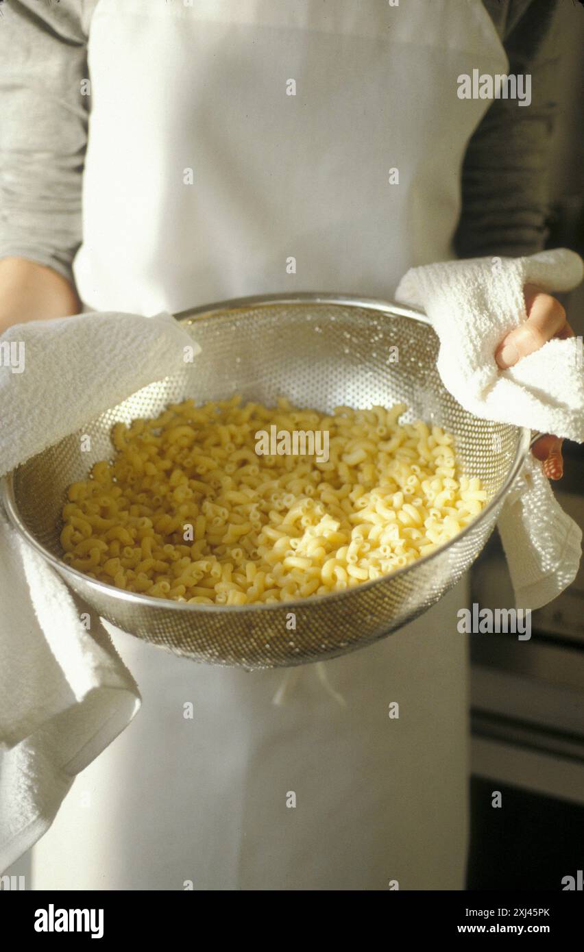 Straining the pasta Stock Photo - Alamy