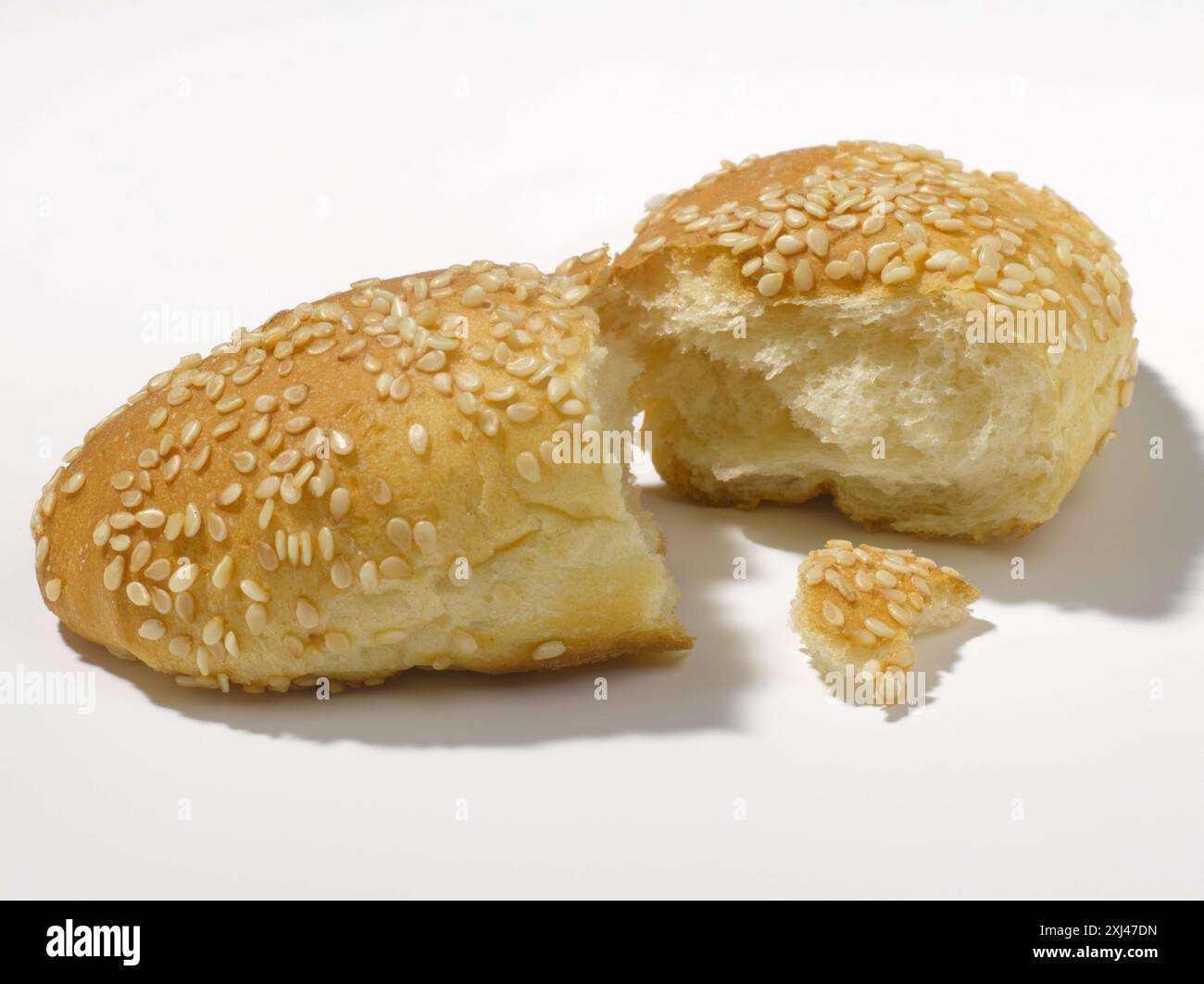 Small bread with sesame seeds broken open Stock Photo - Alamy