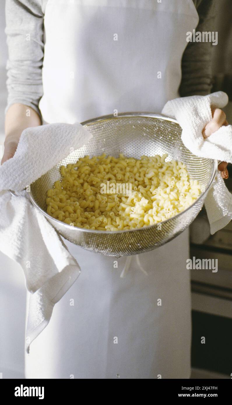 Straining the pasta Stock Photo - Alamy