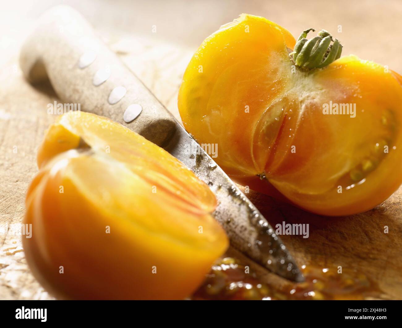 Pineapple tomato cut in two Stock Photo - Alamy
