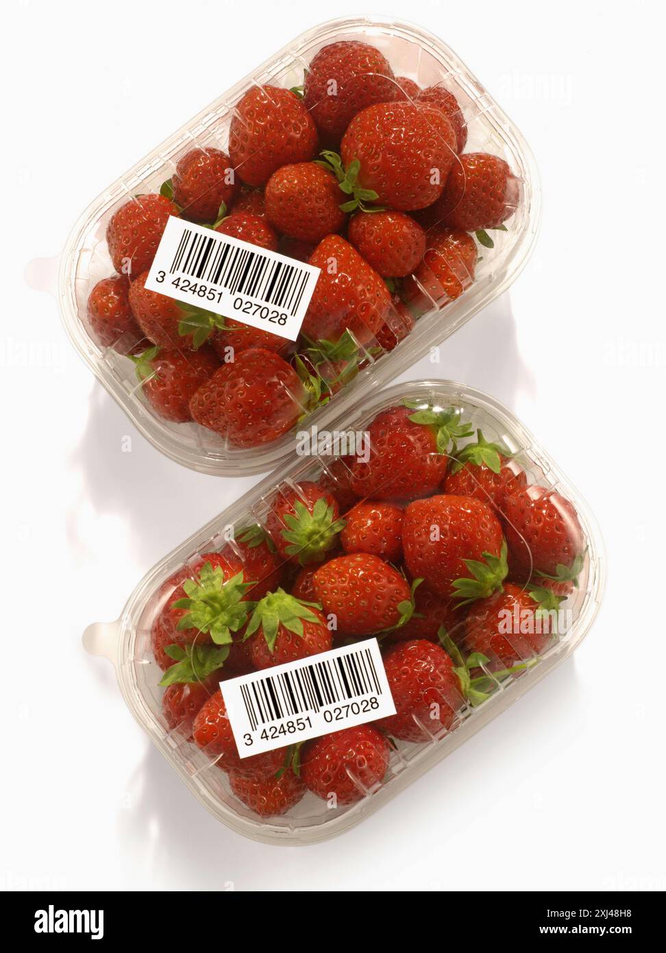Two plastic punnets of industrial strawberries Stock Photo - Alamy