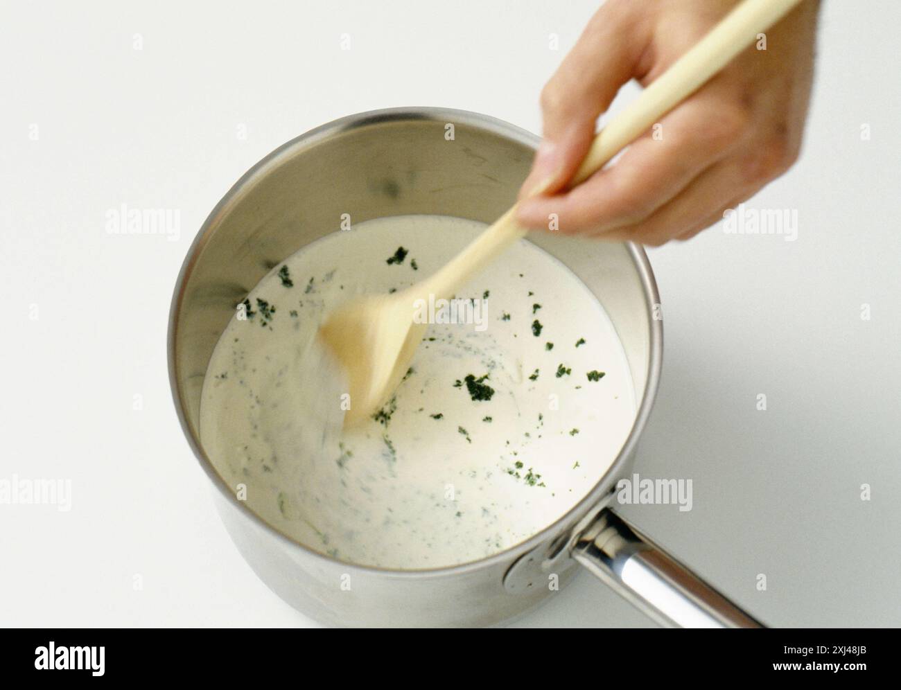 Preparing the parsley and cream sauce Stock Photo - Alamy