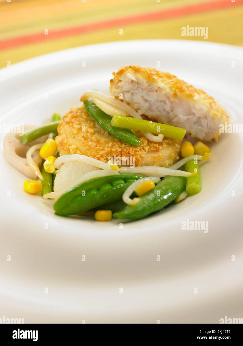 Breaded cod with green vegetables Stock Photo - Alamy