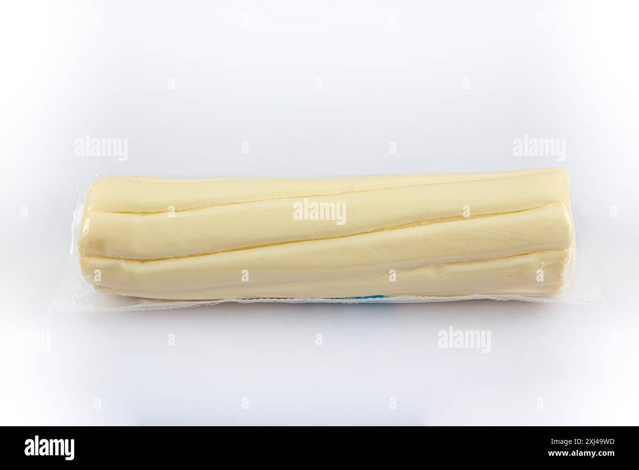 A stick of butter isolated on a white studio background. One kilo of ...