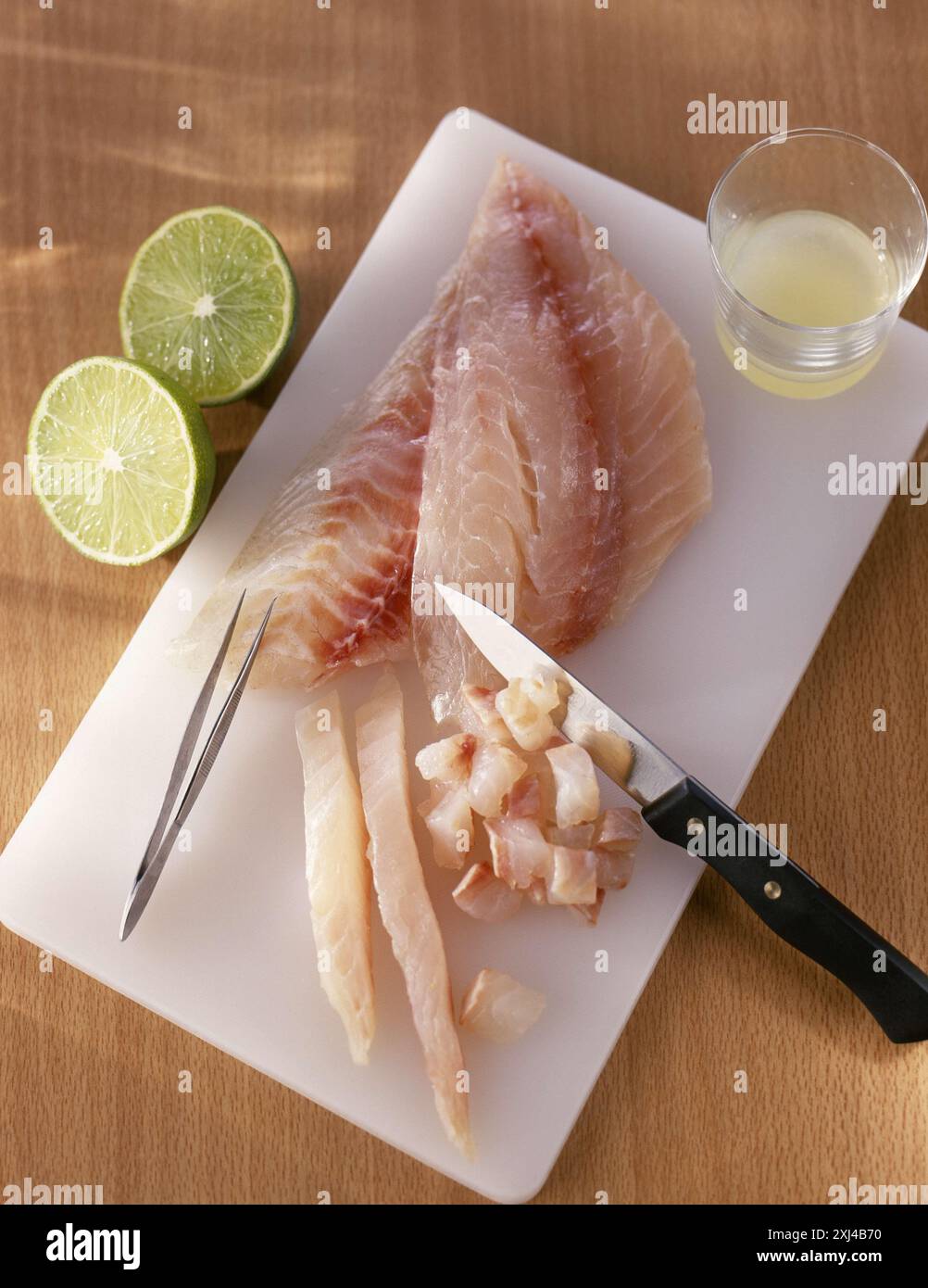 Cutting the fish into dices Stock Photo - Alamy