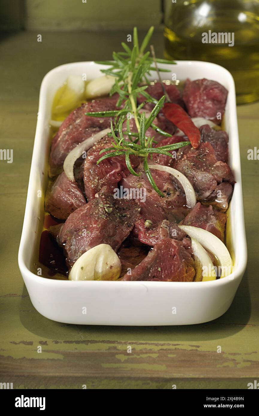 Raw beef marinating in olive oil Stock Photo - Alamy
