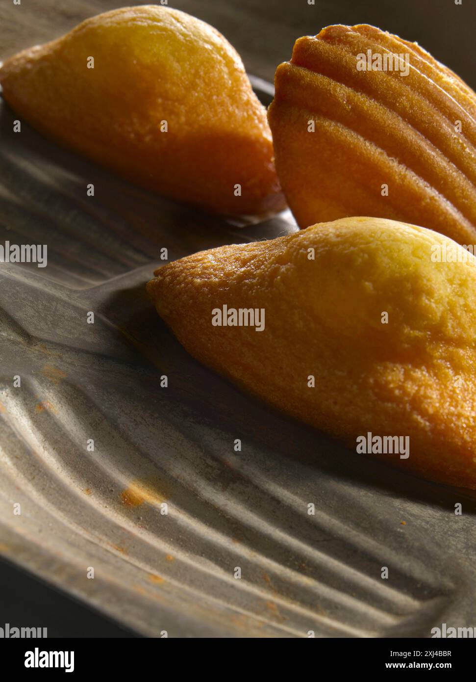 Madeleine in cooking mould Stock Photo - Alamy