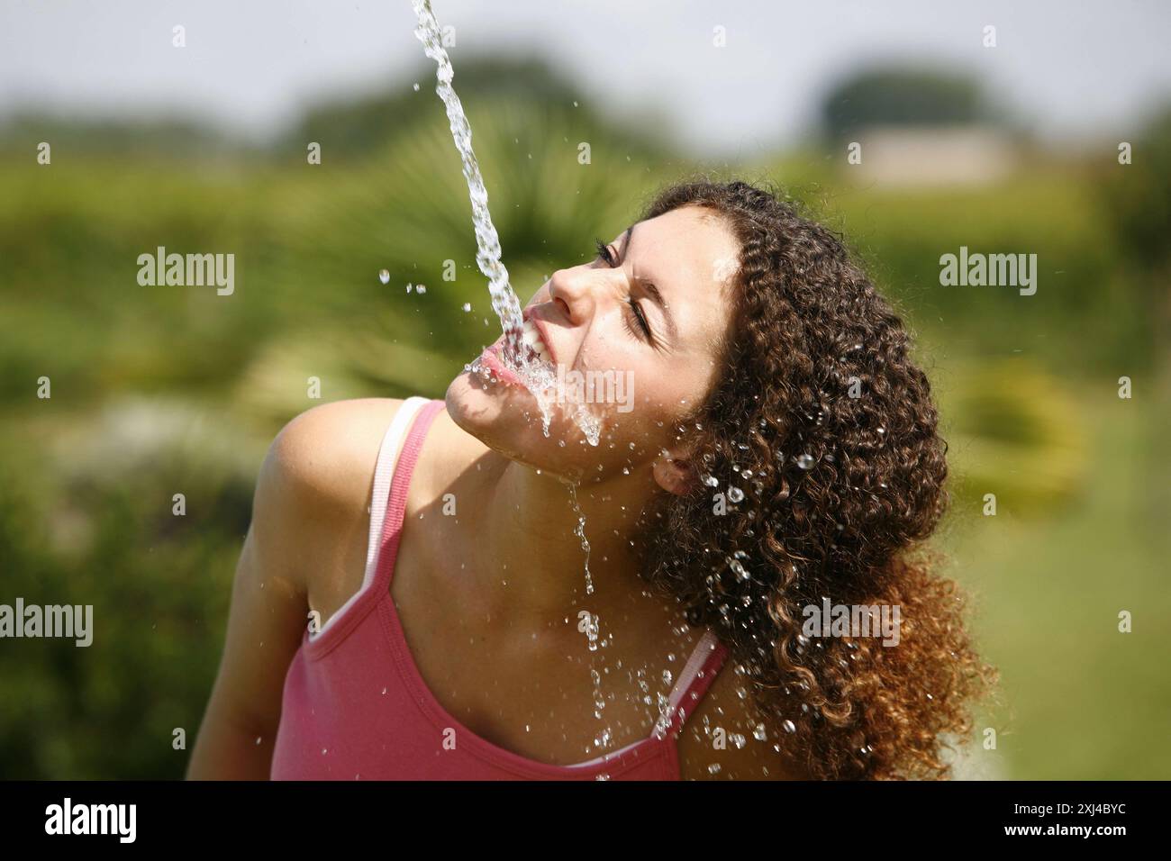 Woman drinking spring water hi-res stock photography and images - Alamy
