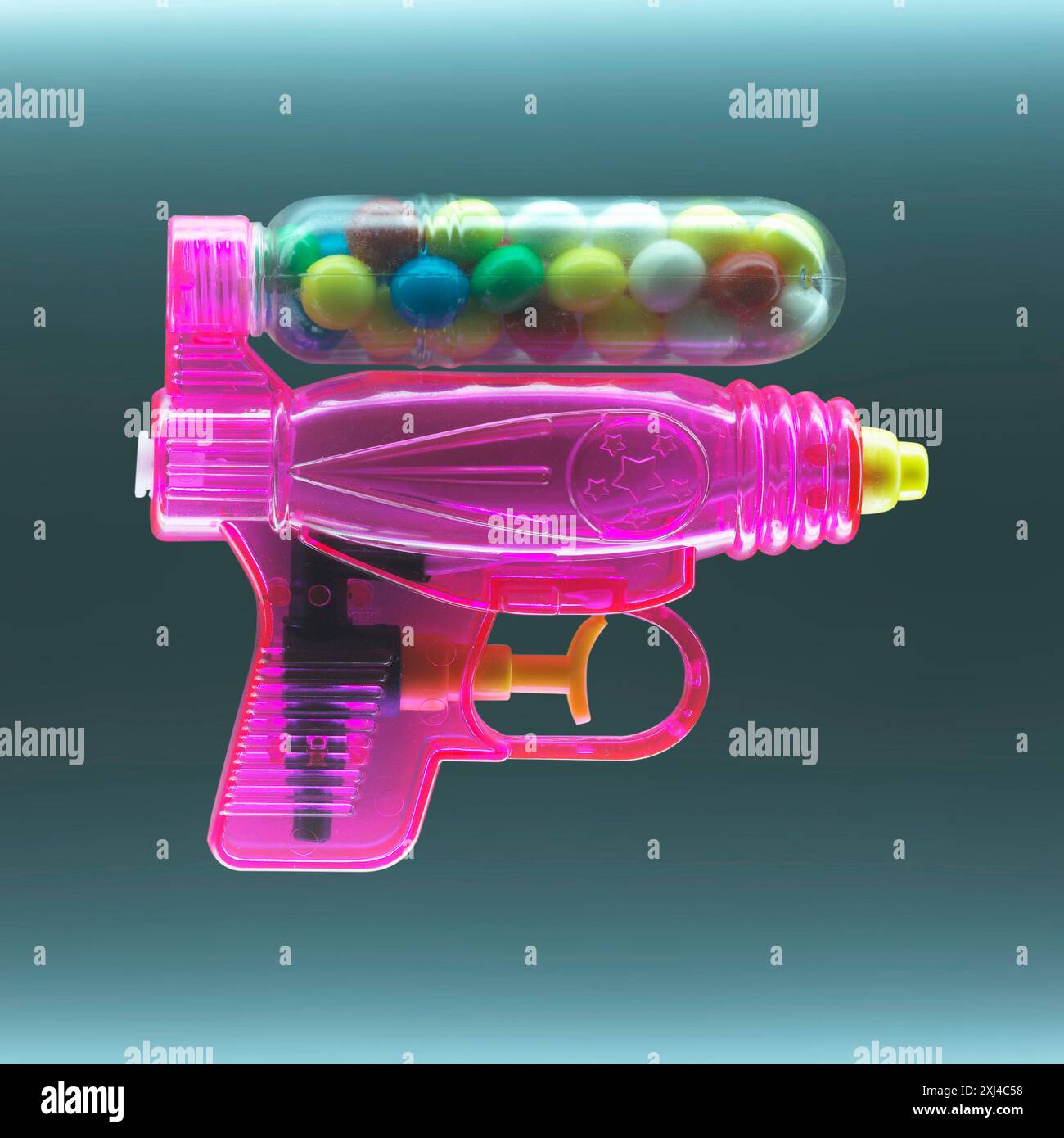 Design gun filled with sweets Stock Photo - Alamy