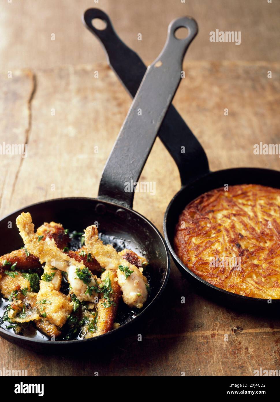 Pan-fried frog's legs with parsley and potato galette Stock Photo - Alamy