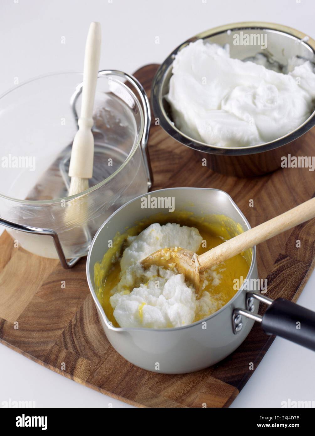 Blending the beaten egg whites to the mixture Stock Photo - Alamy