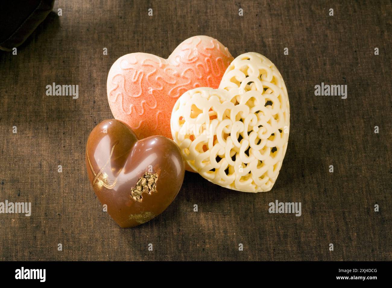 Three heart-shaped candies Stock Photo - Alamy