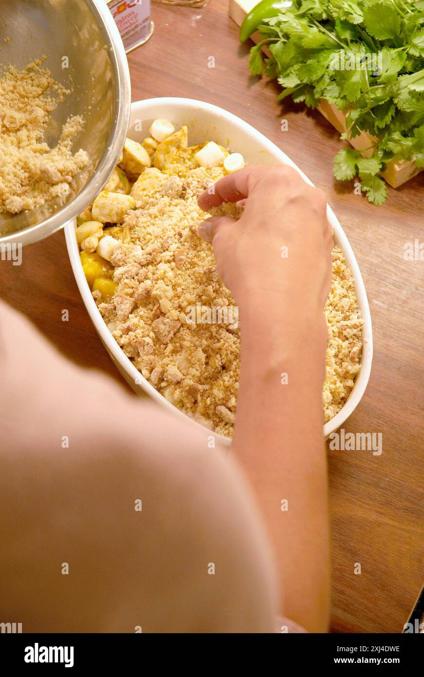 Preparing a chicken and curry crumble Stock Photo - Alamy