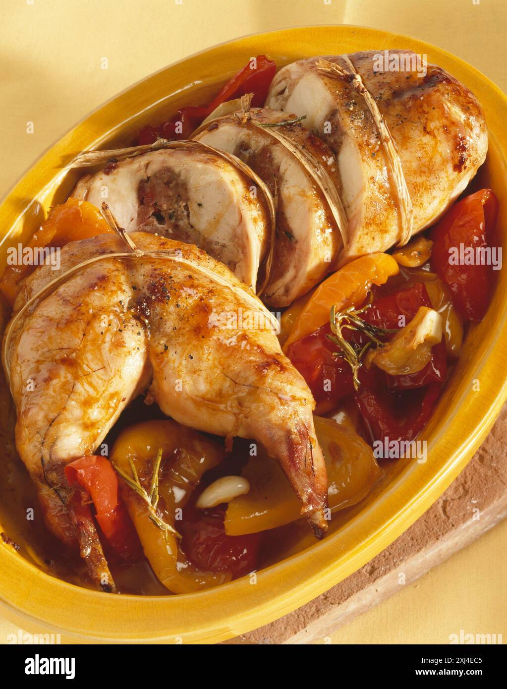 Roast rabbit with confit peppers in honey Stock Photo - Alamy
