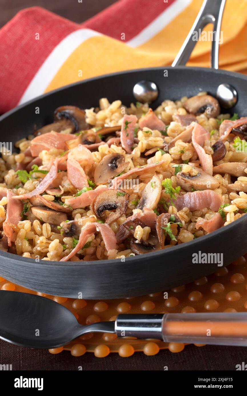 Pan-fried wheat with mushrooms Stock Photo - Alamy