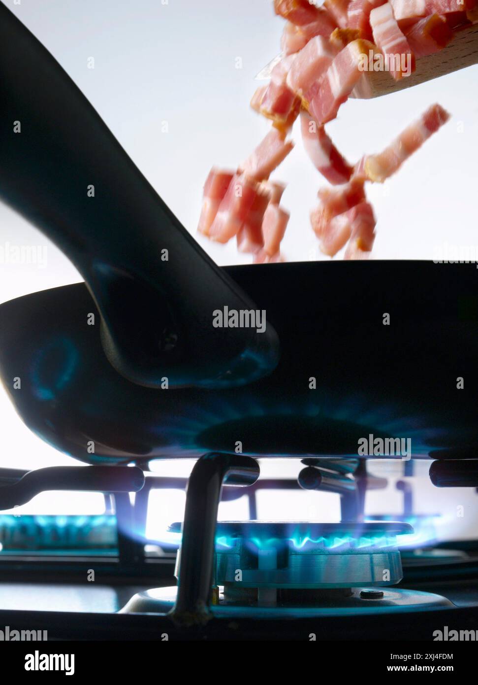 Cooking diced bacon in a frying pan Stock Photo - Alamy
