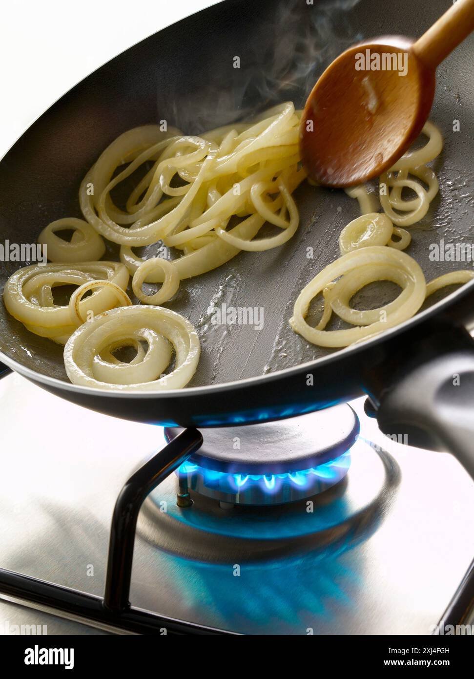Cooking onions in a frying pan Stock Photo - Alamy
