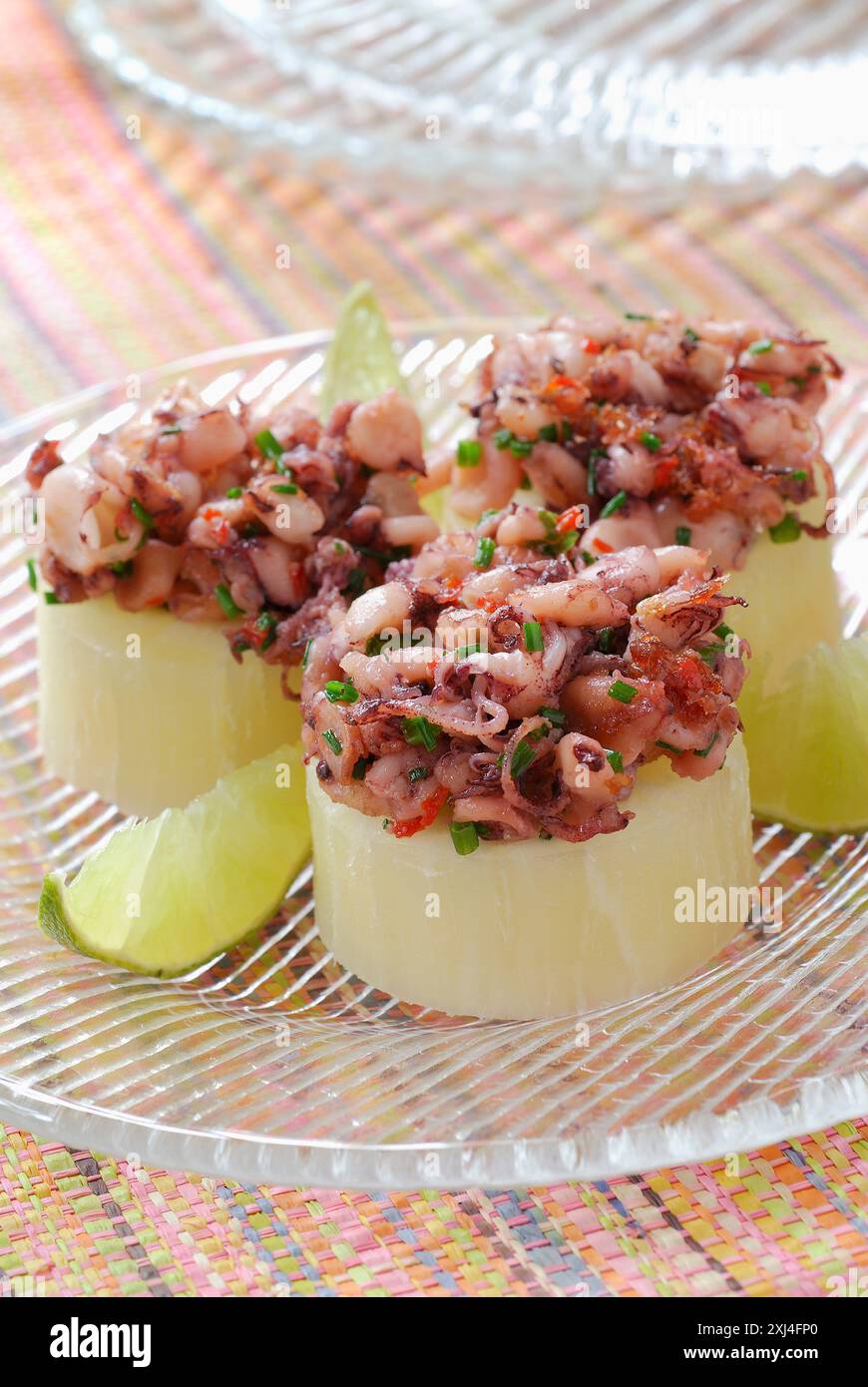 Round slices of cassava topped with Chipirons and West Indian peppers ...