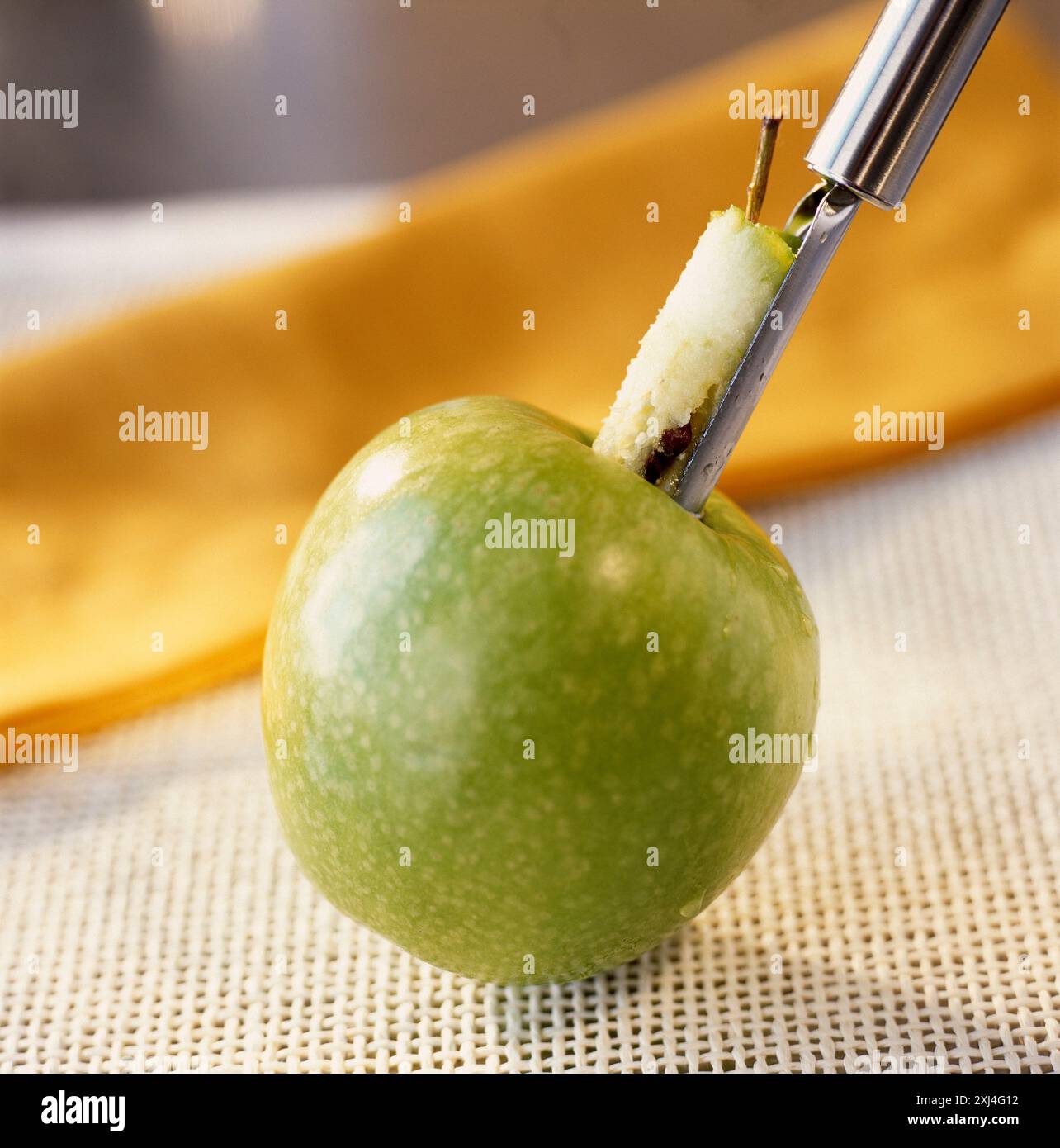 Removing the core from a green apple Stock Photo - Alamy