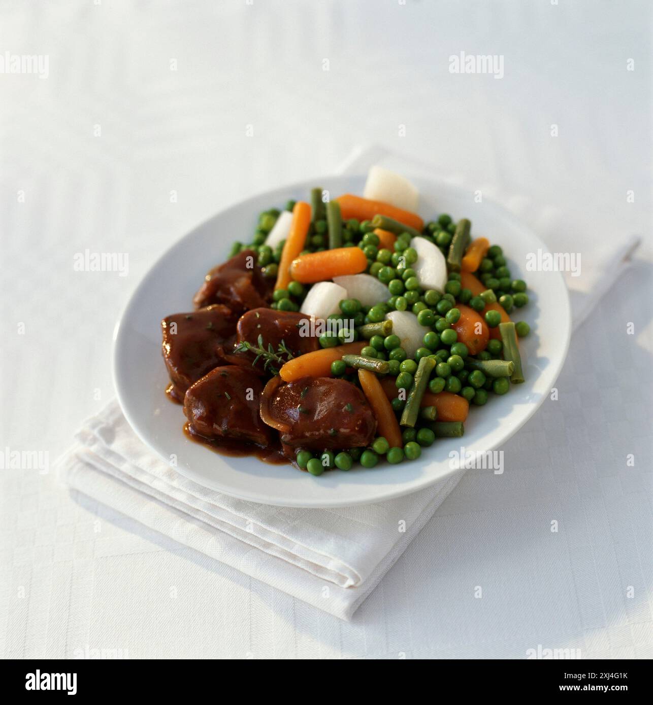 Lamb Navarin with peas and carrots Stock Photo - Alamy