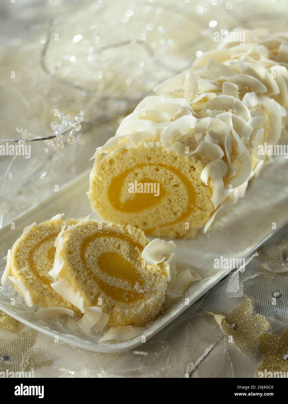mango cream and coconut rolled log cake Stock Photo - Alamy