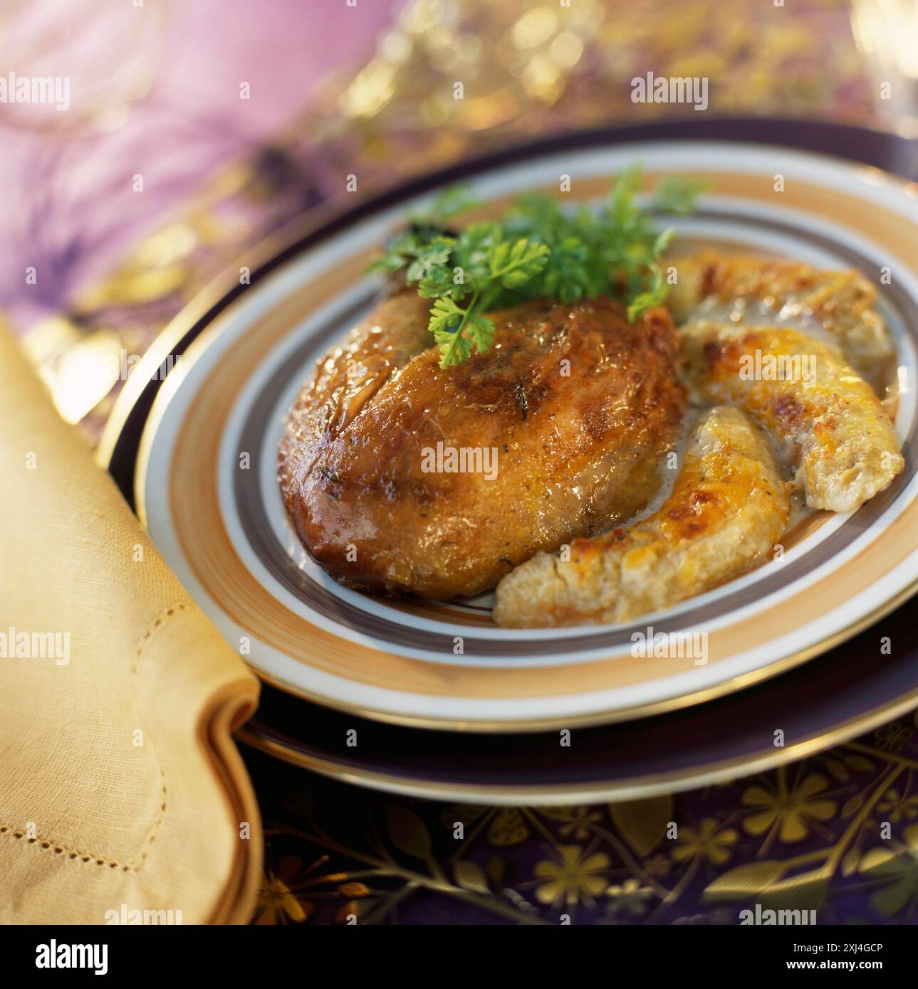 Roast guinea-fowl with curry and banana gratin Stock Photo - Alamy