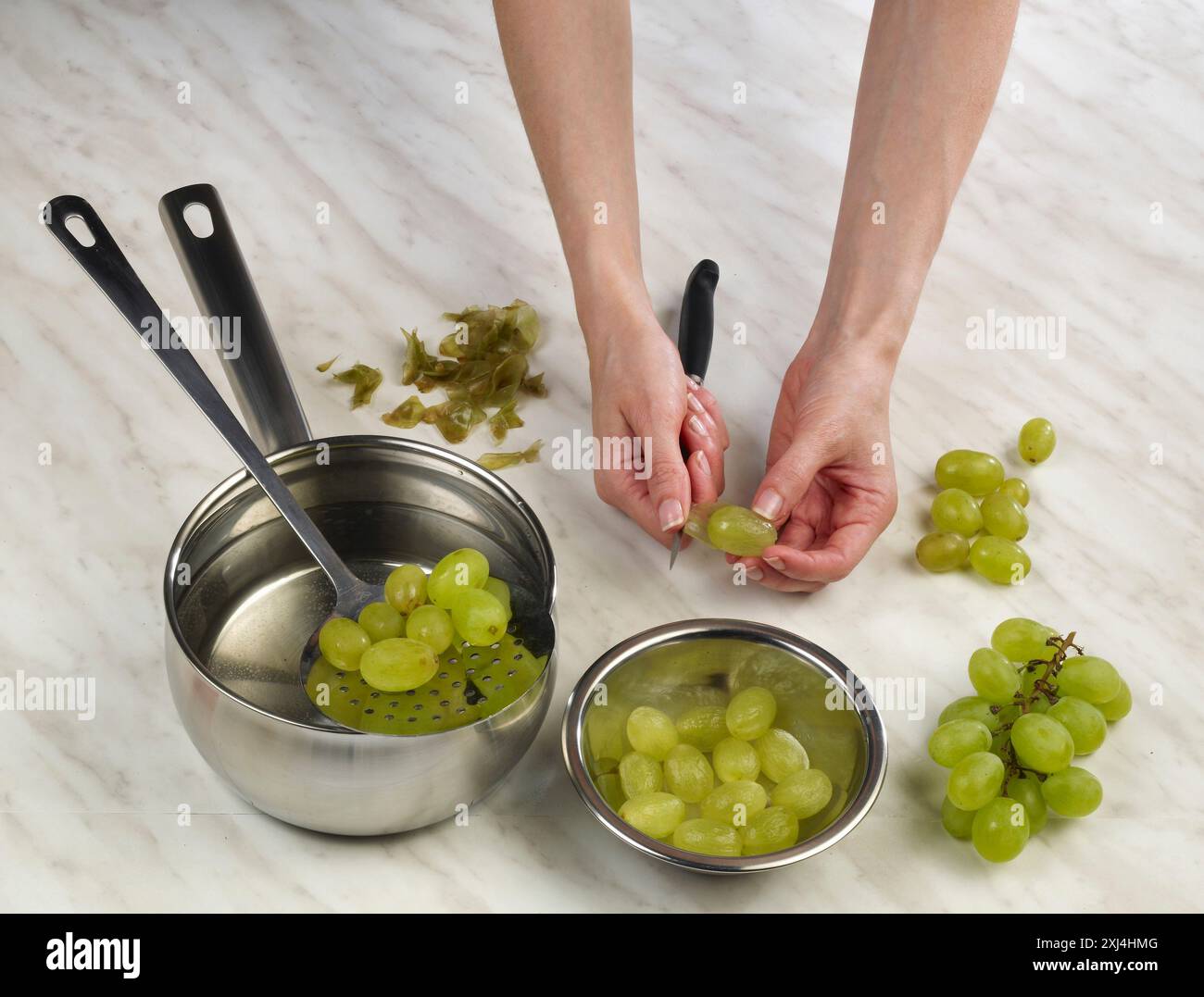 taking the skin off the grapes Stock Photo - Alamy