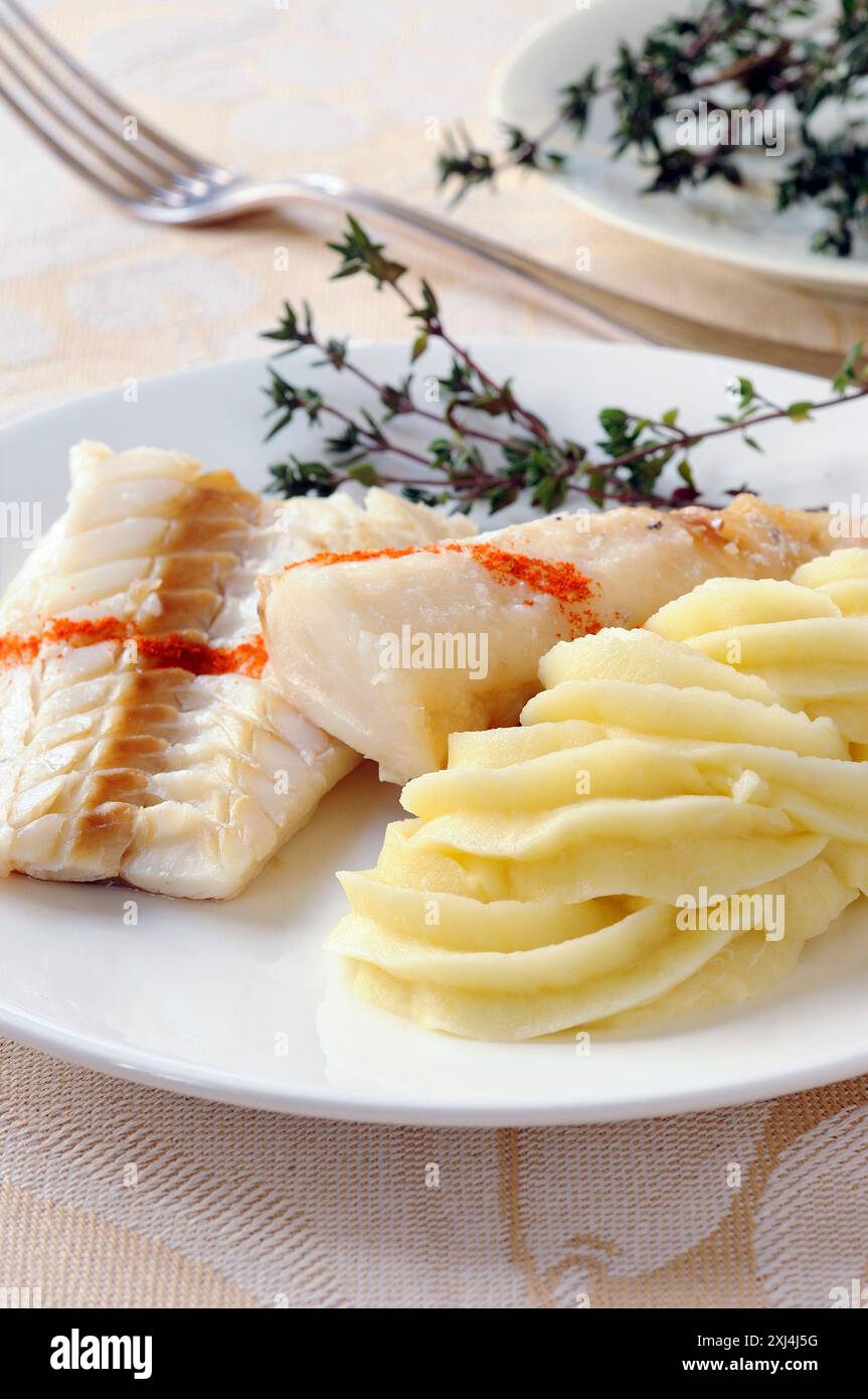 Poached cod with garlic puree Stock Photo - Alamy