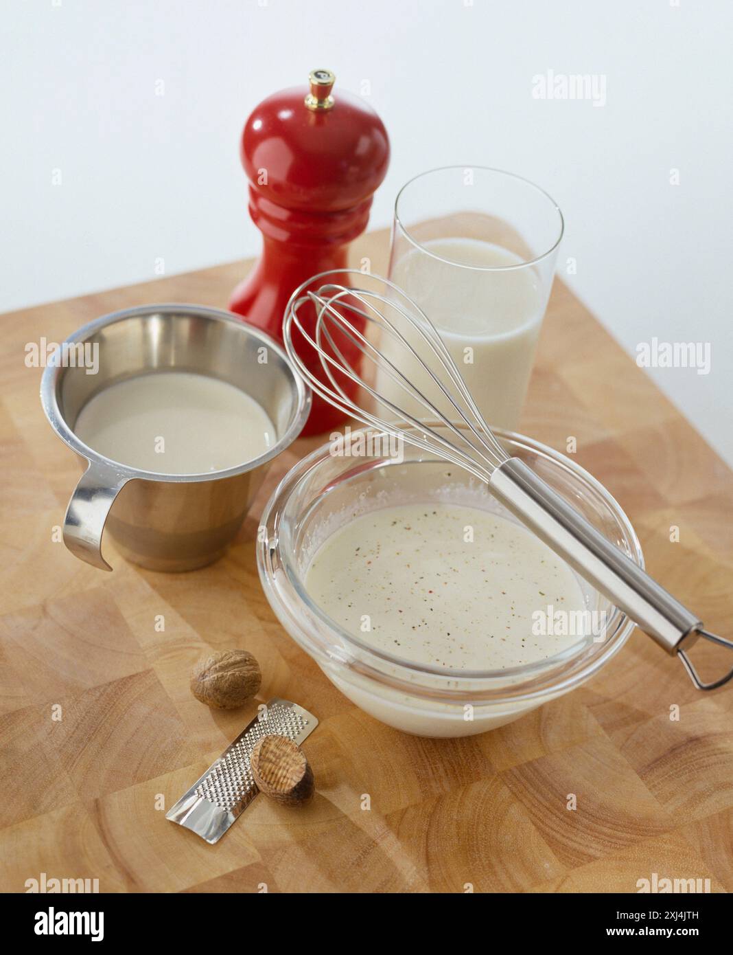 Grating the nutmeg into the mixed milk and cream Stock Photo - Alamy