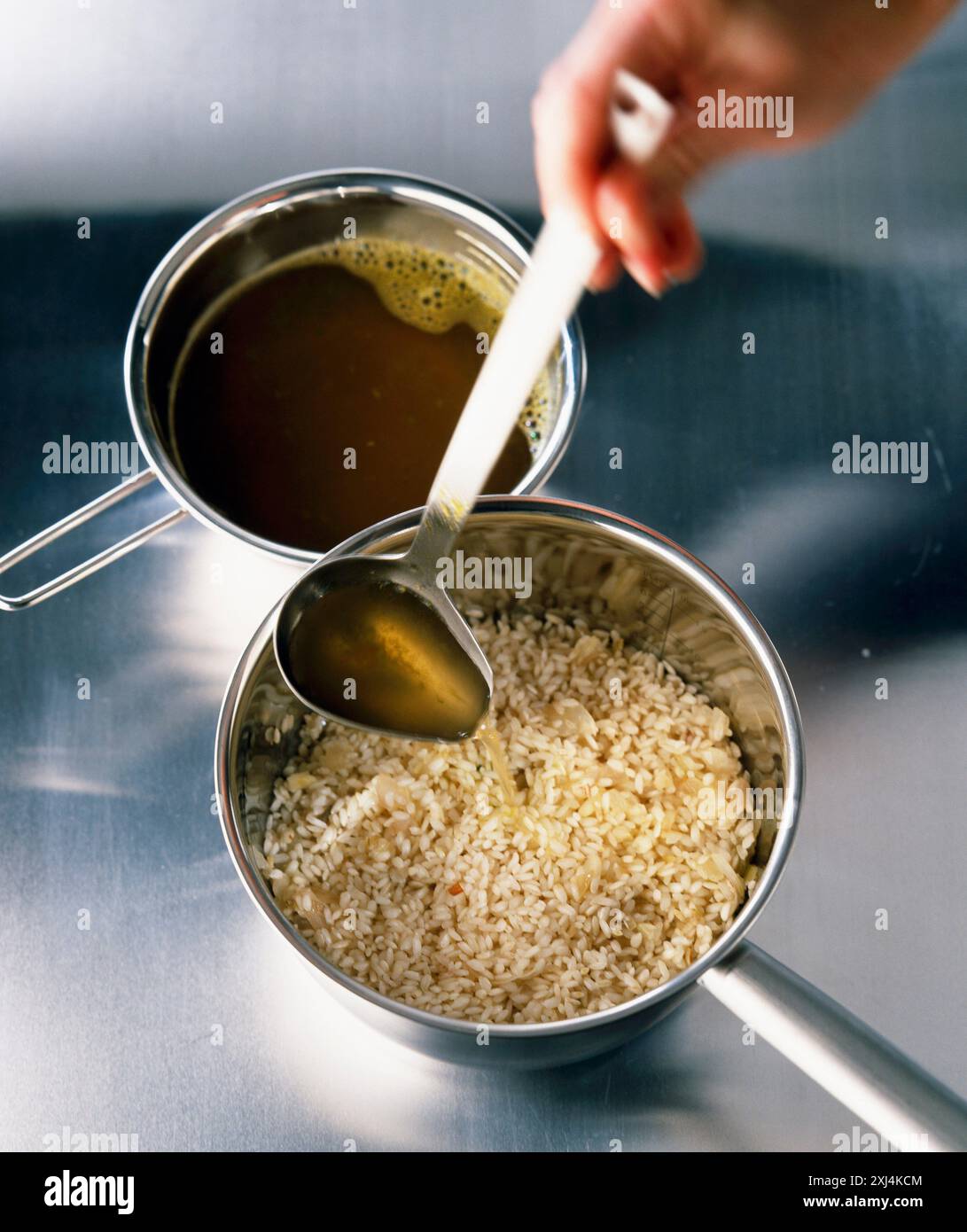 Adding the stock to the rice Stock Photo - Alamy