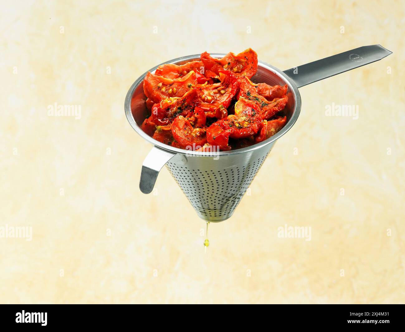 Confit tomatoes in a sieve Stock Photo - Alamy