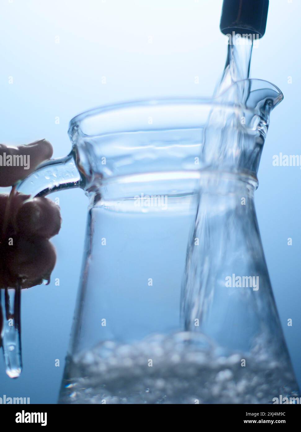 Filling a jug of water under the tap Stock Photo - Alamy