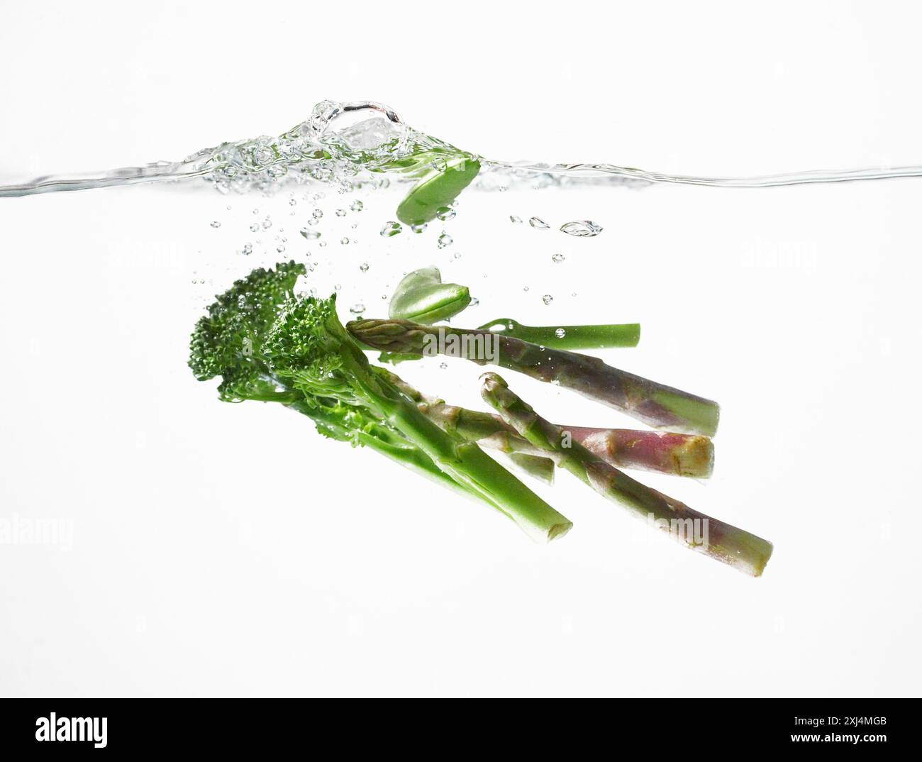 Vegetables falling in the water Stock Photo - Alamy